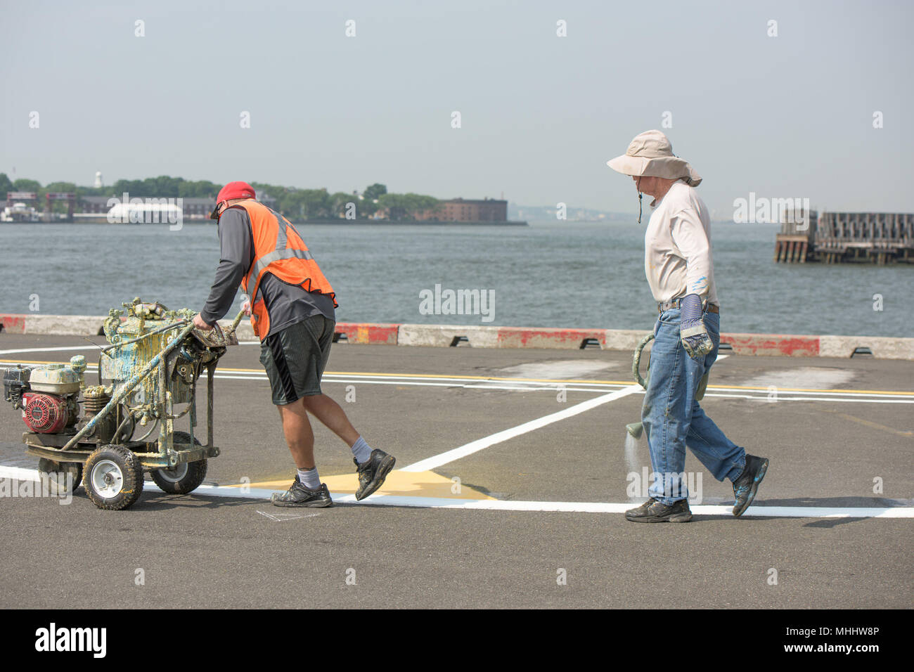 workers tracking lines on asphalt in new york Stock Photo - Alamy