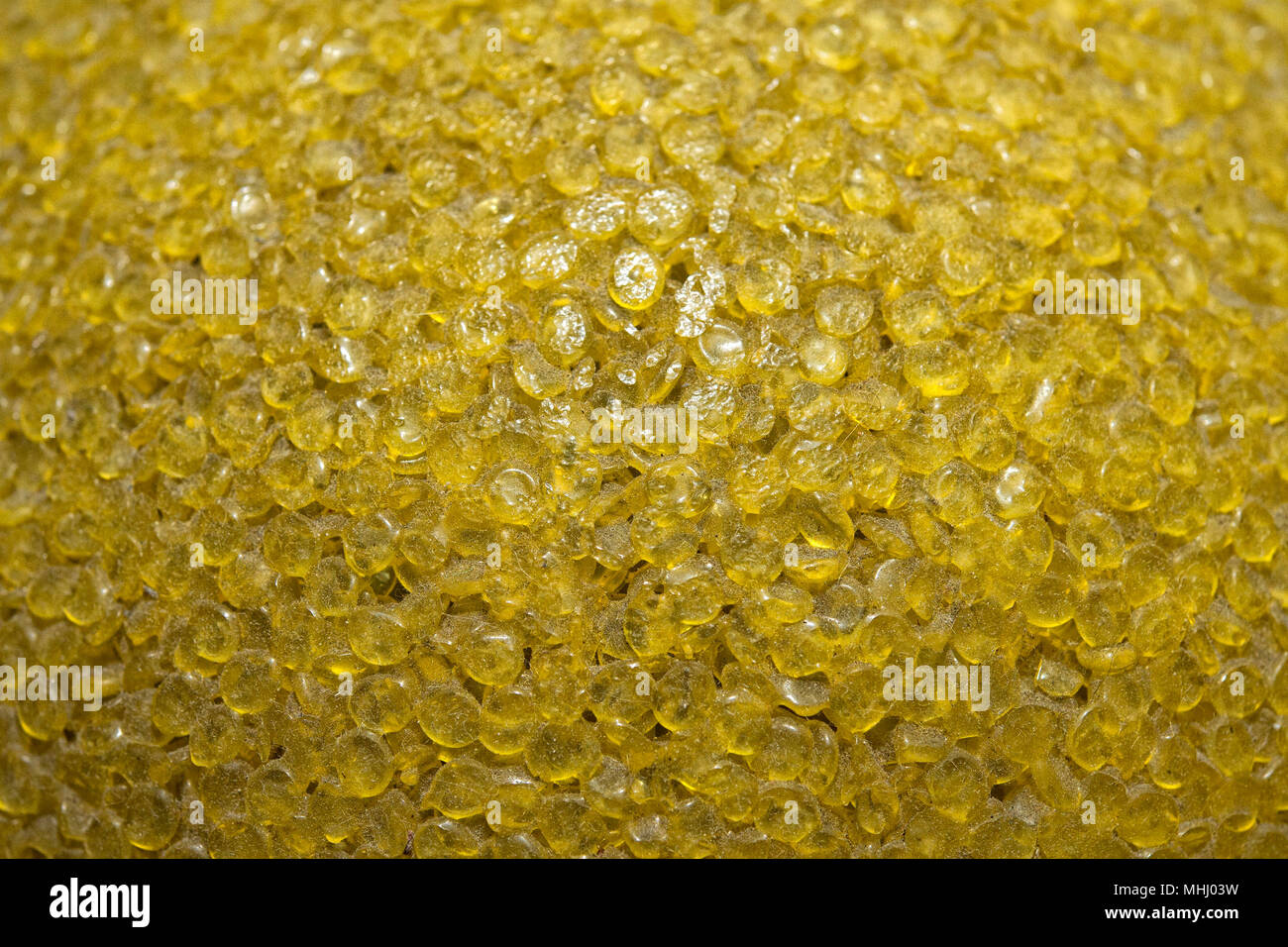 yellow plastic grains detail background Stock Photo - Alamy