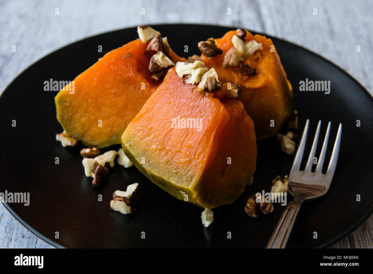 Turkish Pumpkin Dessert / Kabak tatlisi in a black plate Stock Photo ...