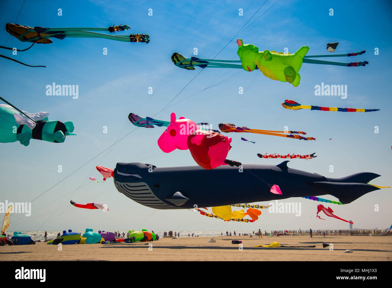 Many colorful kites in different shapes on the beach at Cervia ...