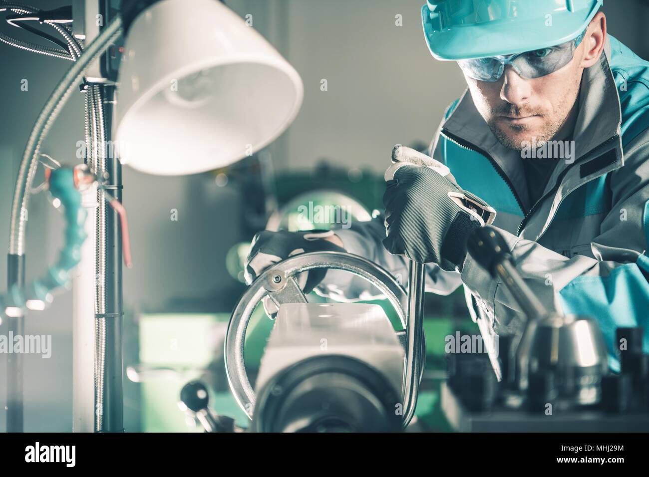 Lathe Metalwork Production Line. Caucasian Worker Preparing Machine To ...
