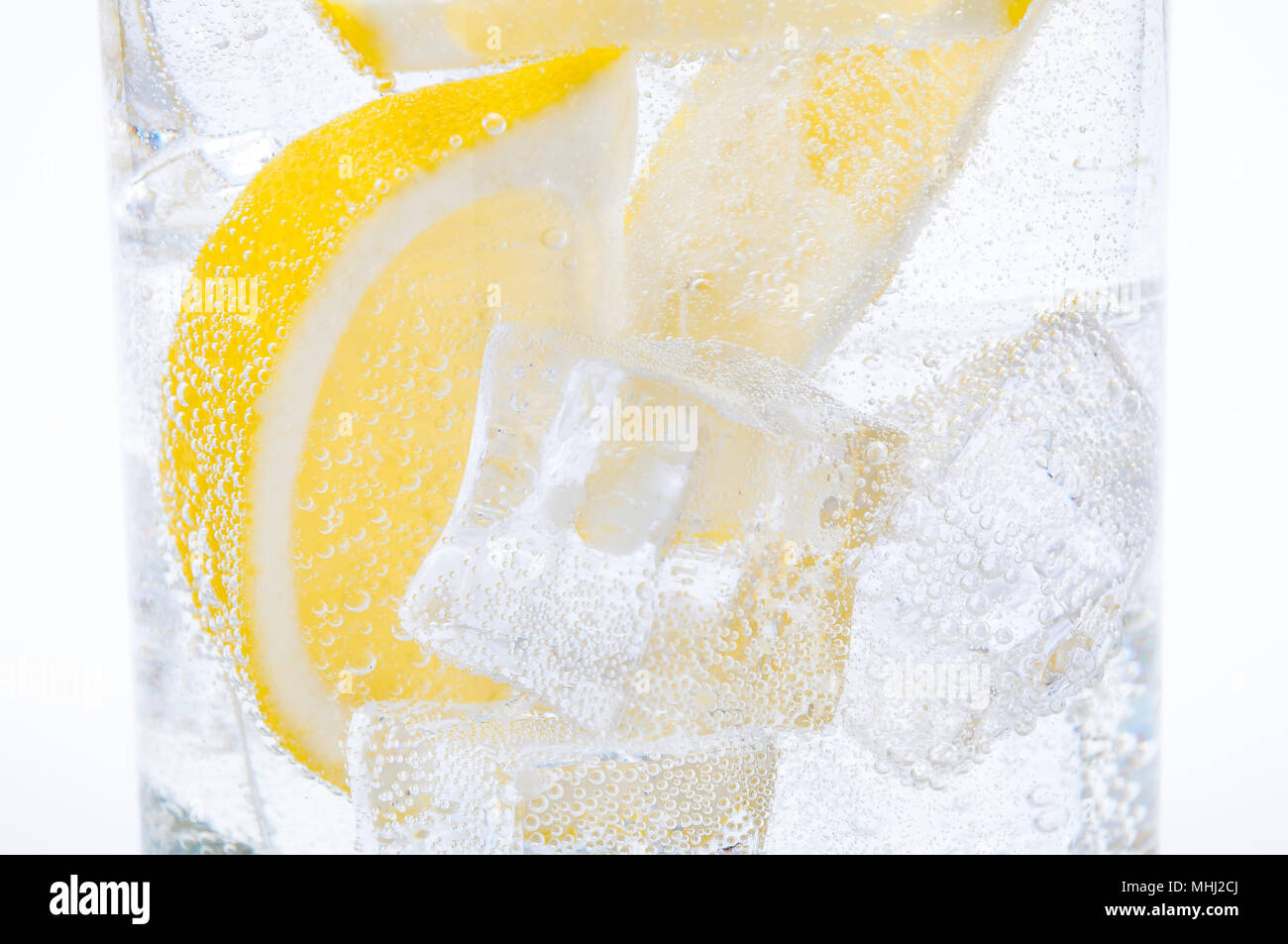 Ice, lemon slices and crystal clear water in a glass Stock Photo - Alamy