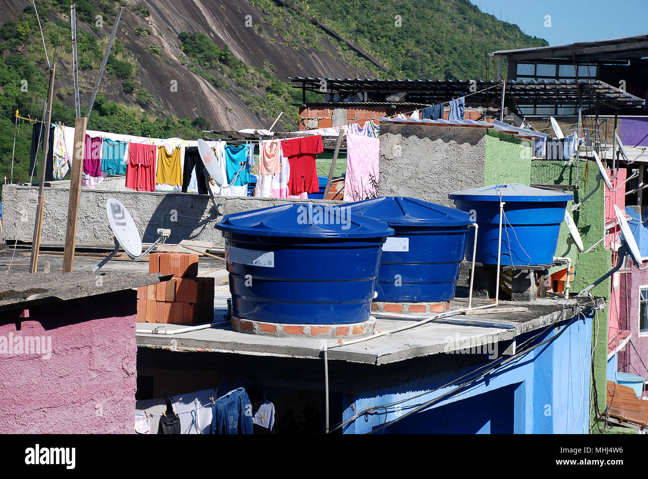 Water tanks on the roof of a house in a favela on the hillside of a ...