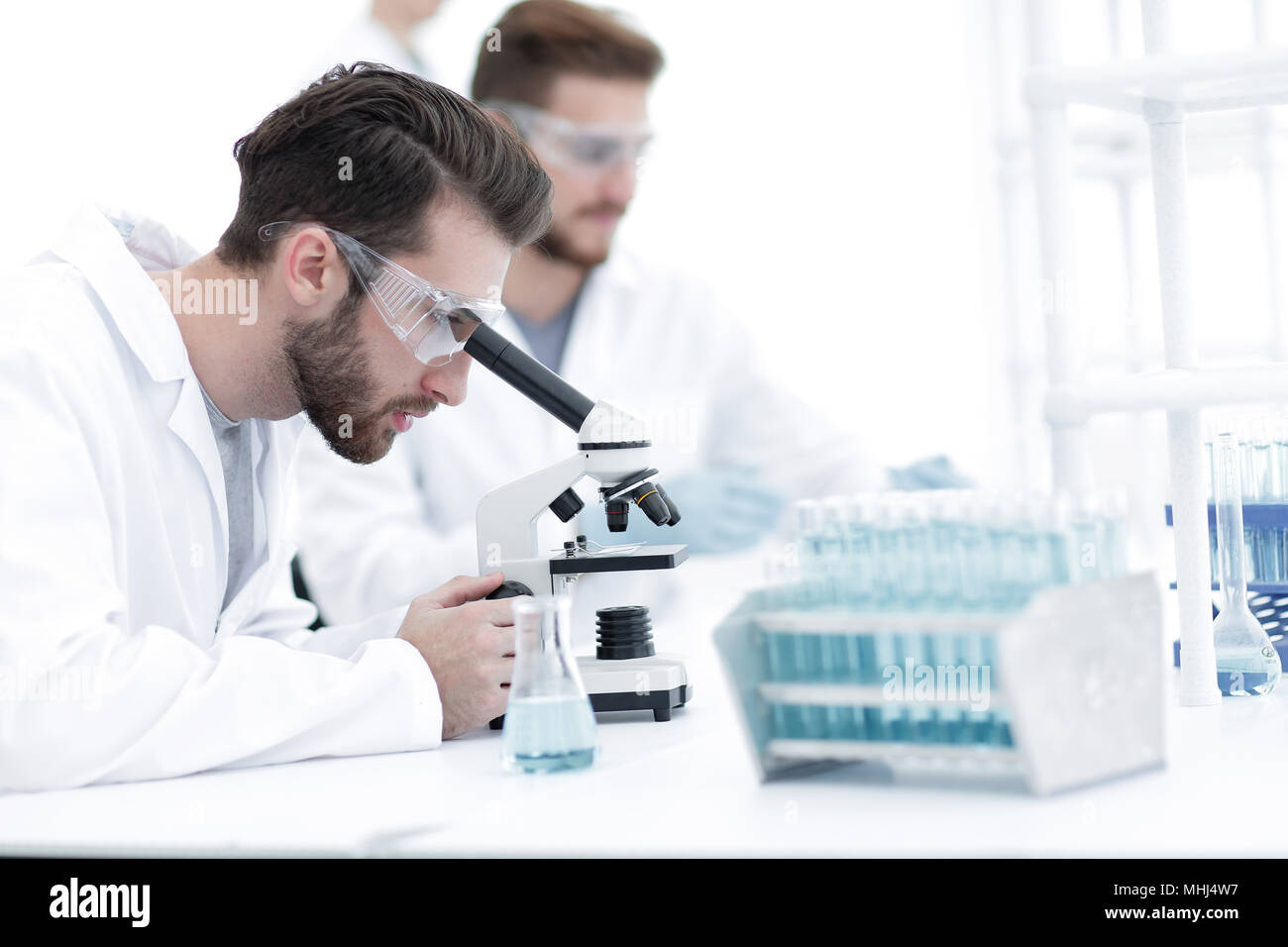 biologist explores the substance under the microscope Stock Photo - Alamy