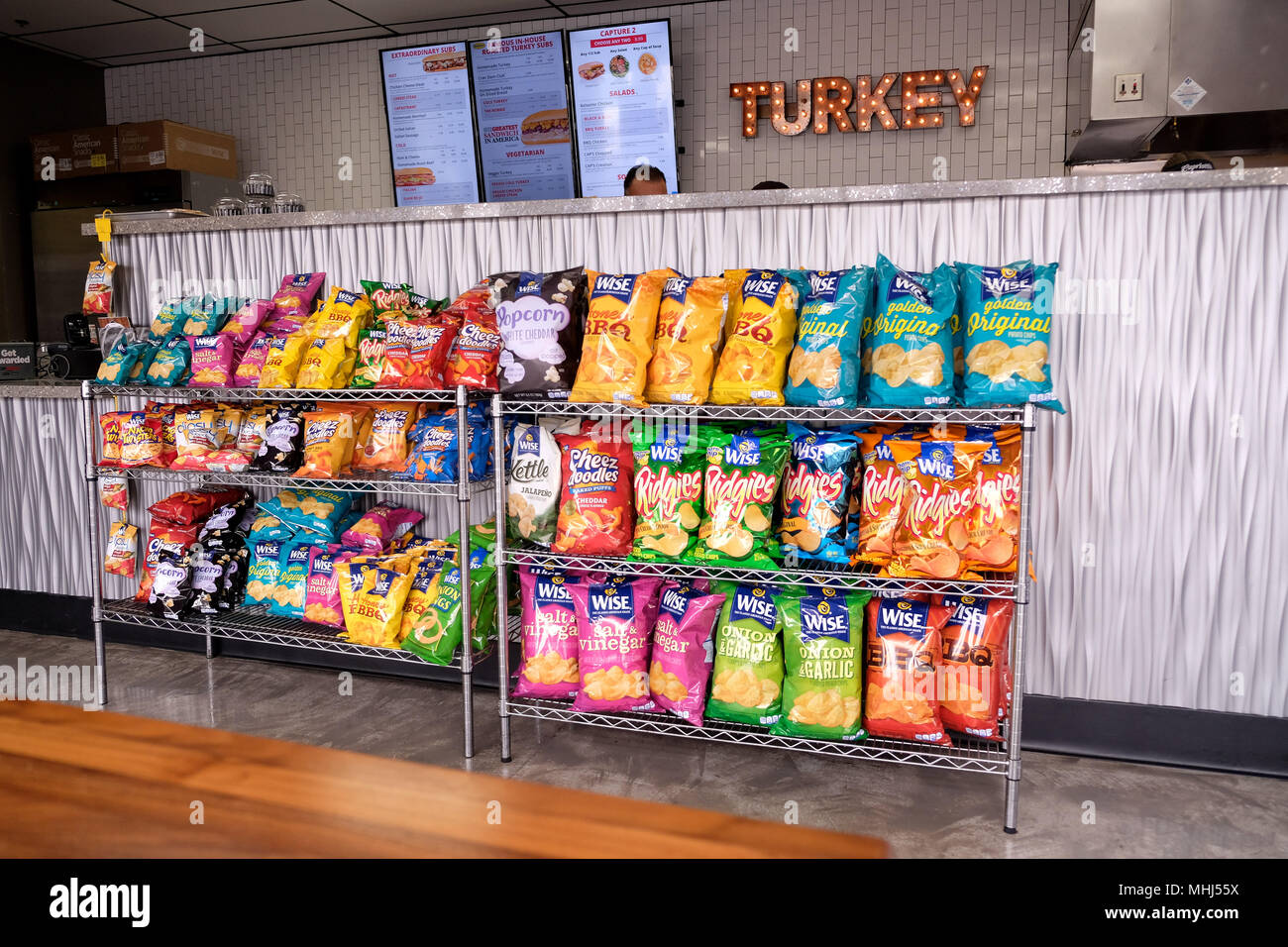 bags of crisps chips on sale in shop Stock Photo - Alamy