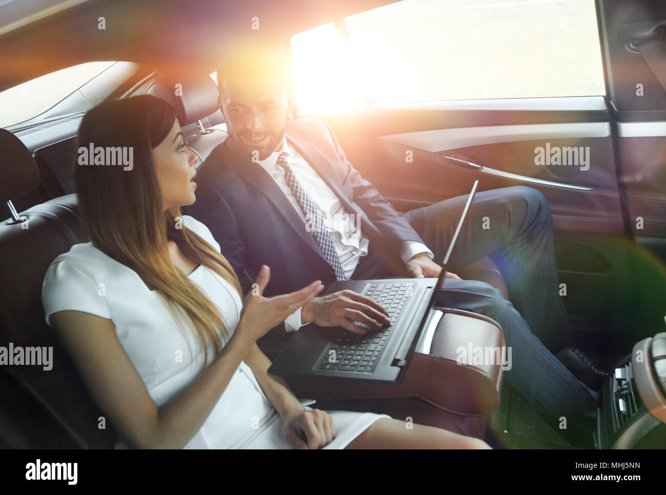 Conversation of two business people in driving car Stock Photo - Alamy