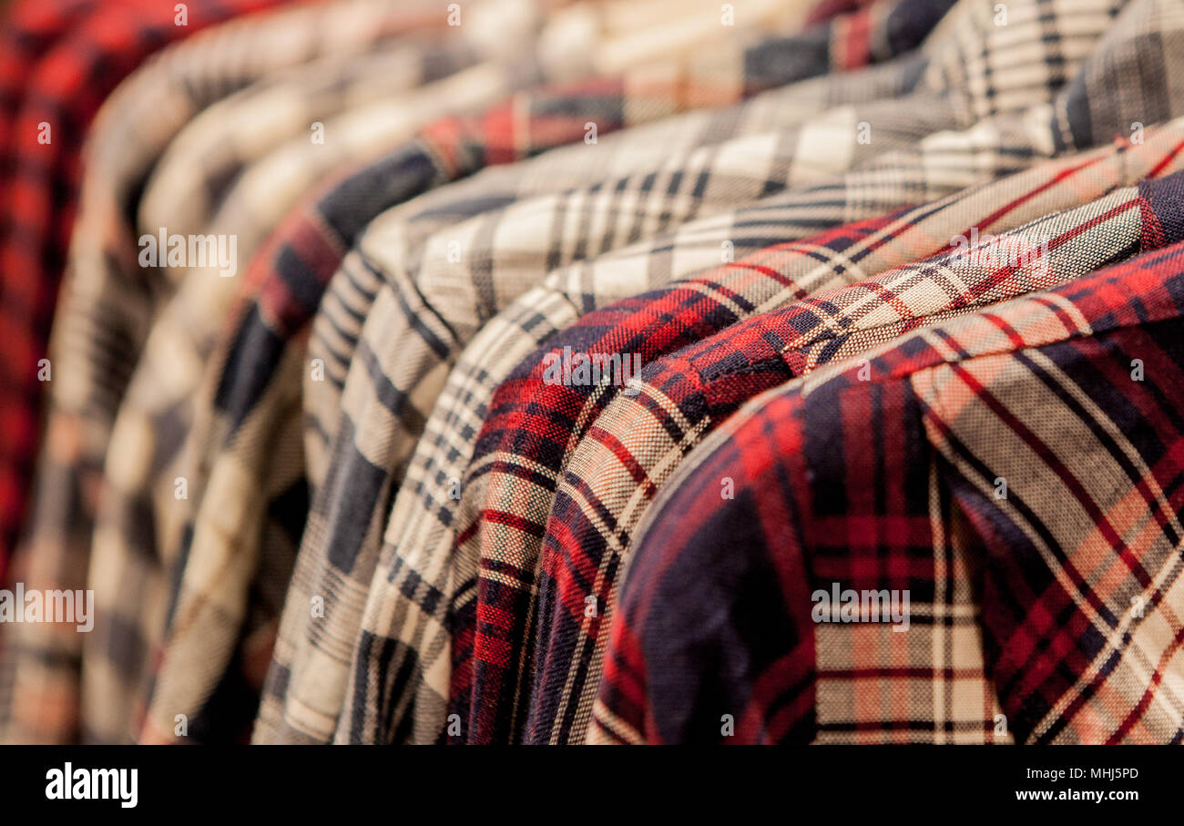 Clothes hang on a shelf . Cloth Hangers with Shirts. Men's stylish ...