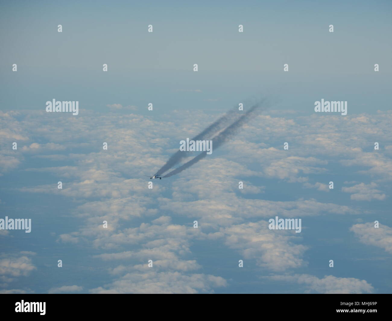 Panorama of blue sky and cloud and plane approaches as seen through ...