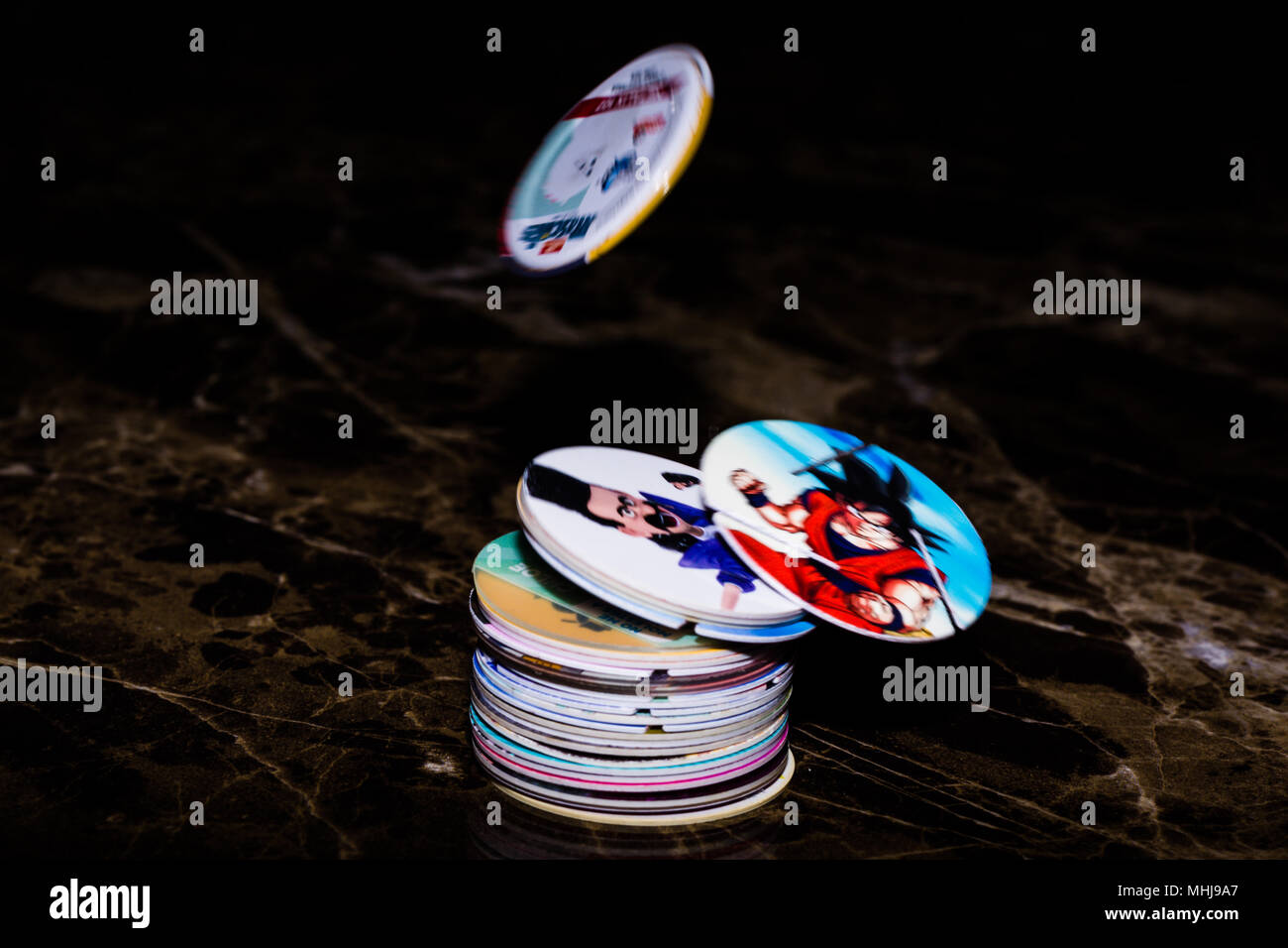 Colorful POGS of various cartoon characters Stock Photo - Alamy