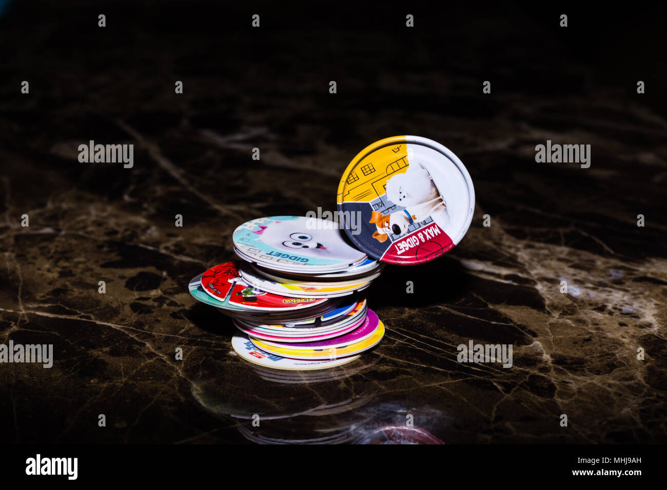 Colorful POGS of various cartoon characters Stock Photo - Alamy
