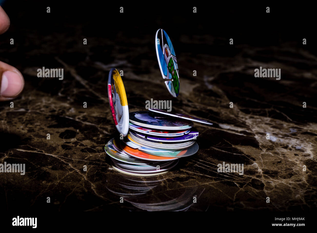 Colorful POGS of various cartoon characters Stock Photo - Alamy