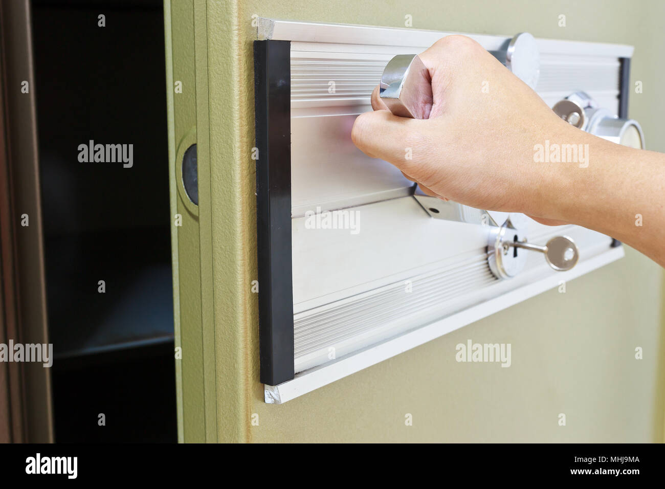 hand pull opening green steel bank safe Stock Photo - Alamy