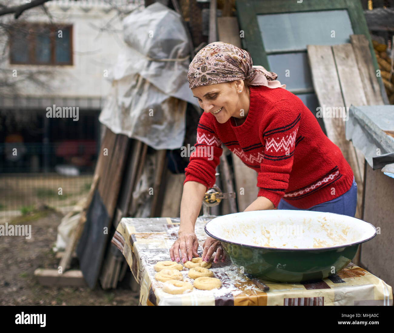 Happy rural woman cooking bagels in the countryside, outdoor Stock ...