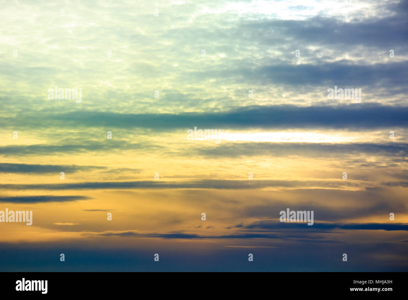 Cumulus sunset clouds with colorful sun setting downs Stock Photo - Alamy