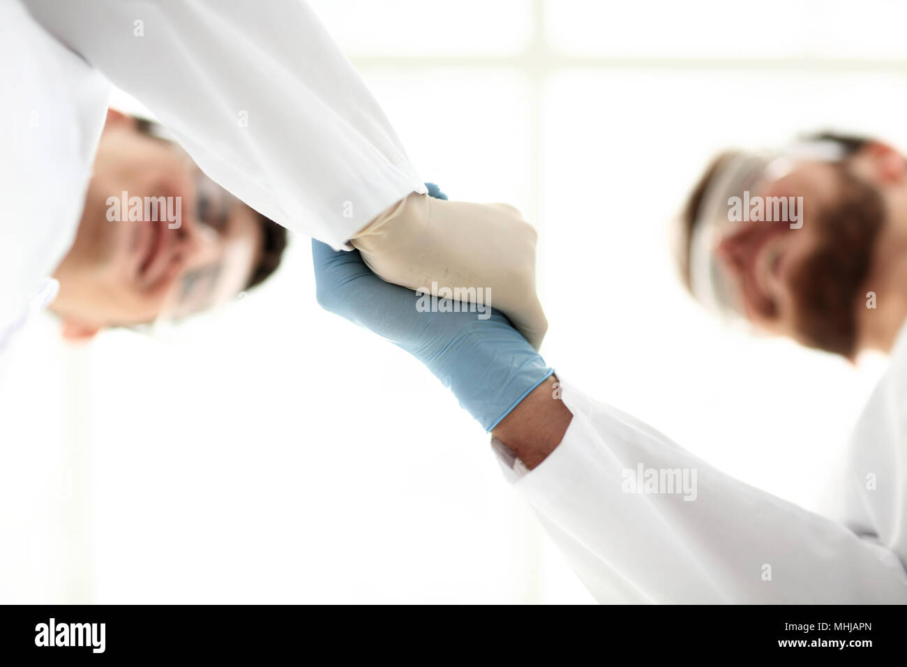 Two scientists handshake hi-res stock photography and images - Alamy