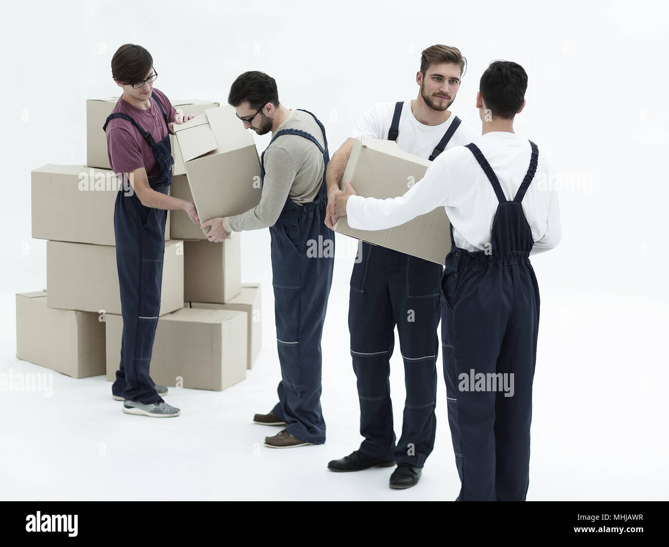 Movers lifting stack of cardboard moving boxes isolated on white Stock ...