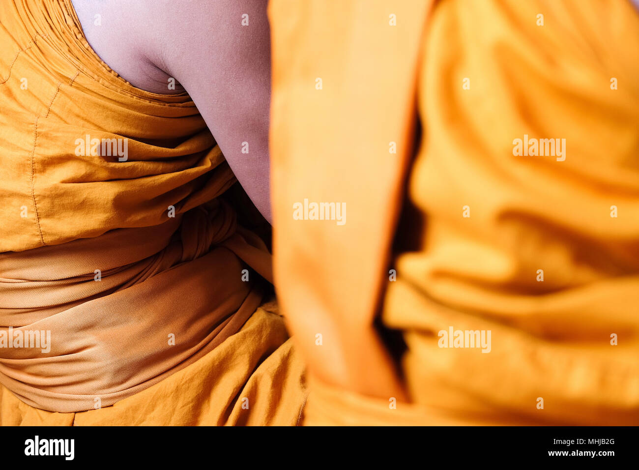 Yellow robe of Buddhist monks, Closeup on buddhist monk Stock Photo - Alamy