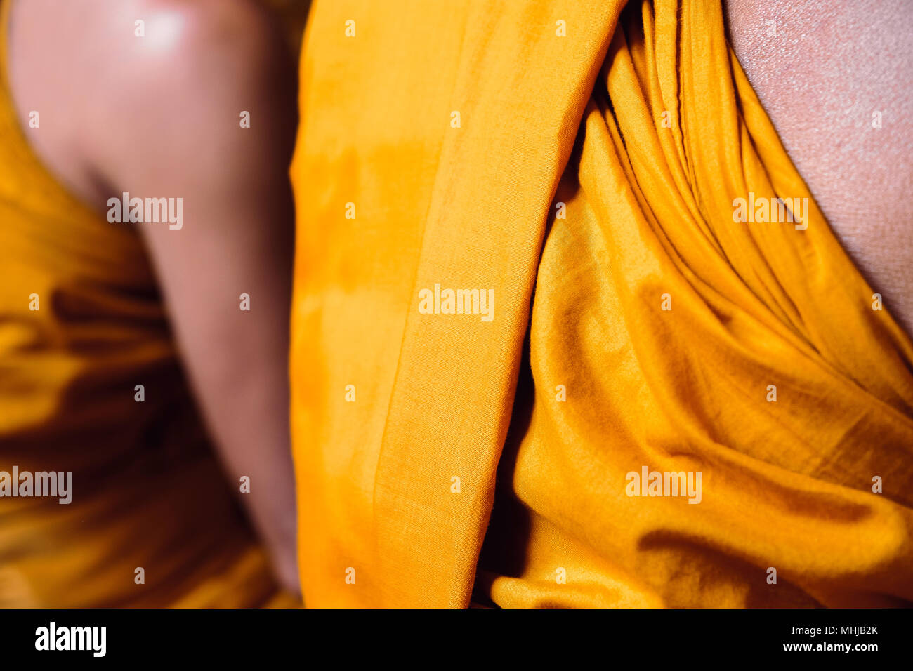 Yellow robe of Buddhist monks, Closeup on buddhist monk Stock Photo - Alamy