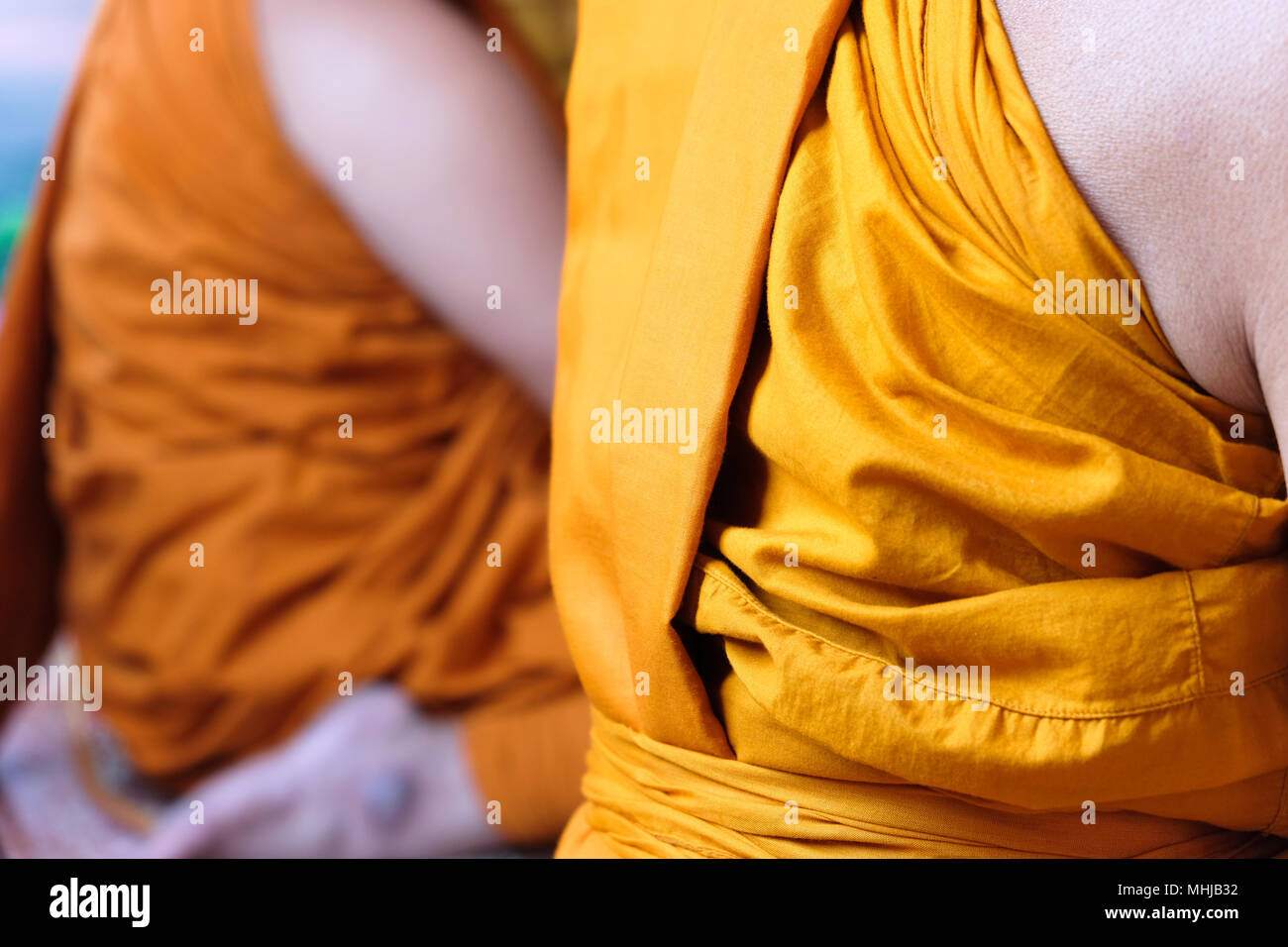 Yellow robe of Buddhist monks, Closeup on buddhist monk Stock Photo - Alamy