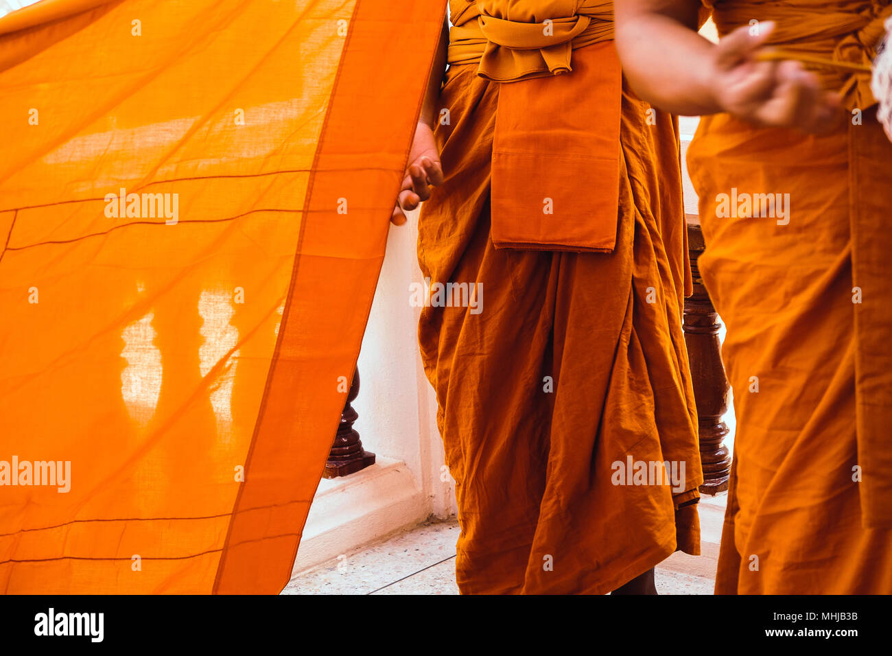 Yellow robe of Buddhist monks, Closeup on buddhist monk Stock Photo - Alamy