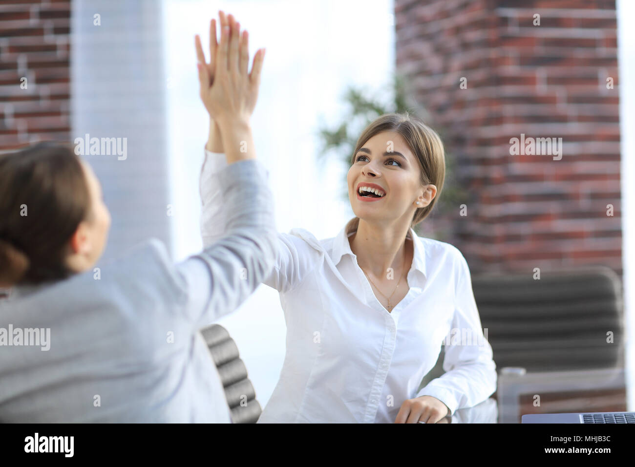 members of the business team giving each other a high five Stock Photo ...