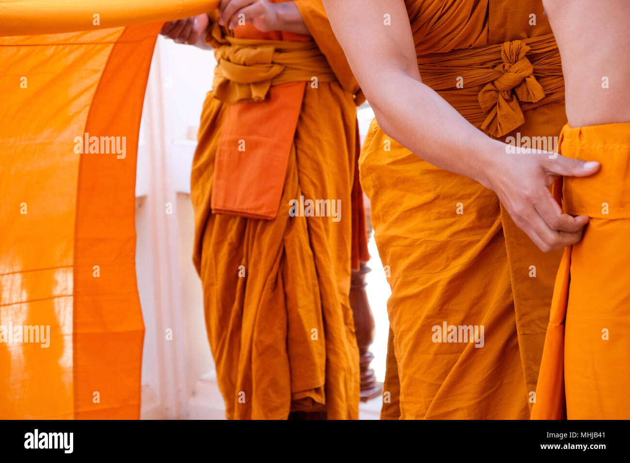 Yellow robe of Buddhist monks, Closeup on buddhist monk Stock Photo - Alamy