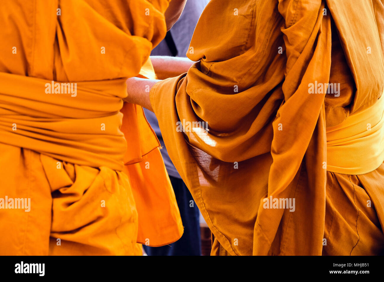 Yellow robe of Buddhist monks, Closeup on buddhist monk Stock Photo - Alamy