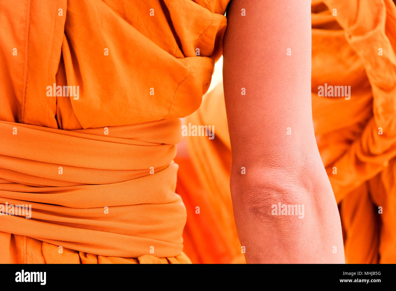 Yellow robe of Buddhist monks, Closeup on buddhist monk Stock Photo - Alamy