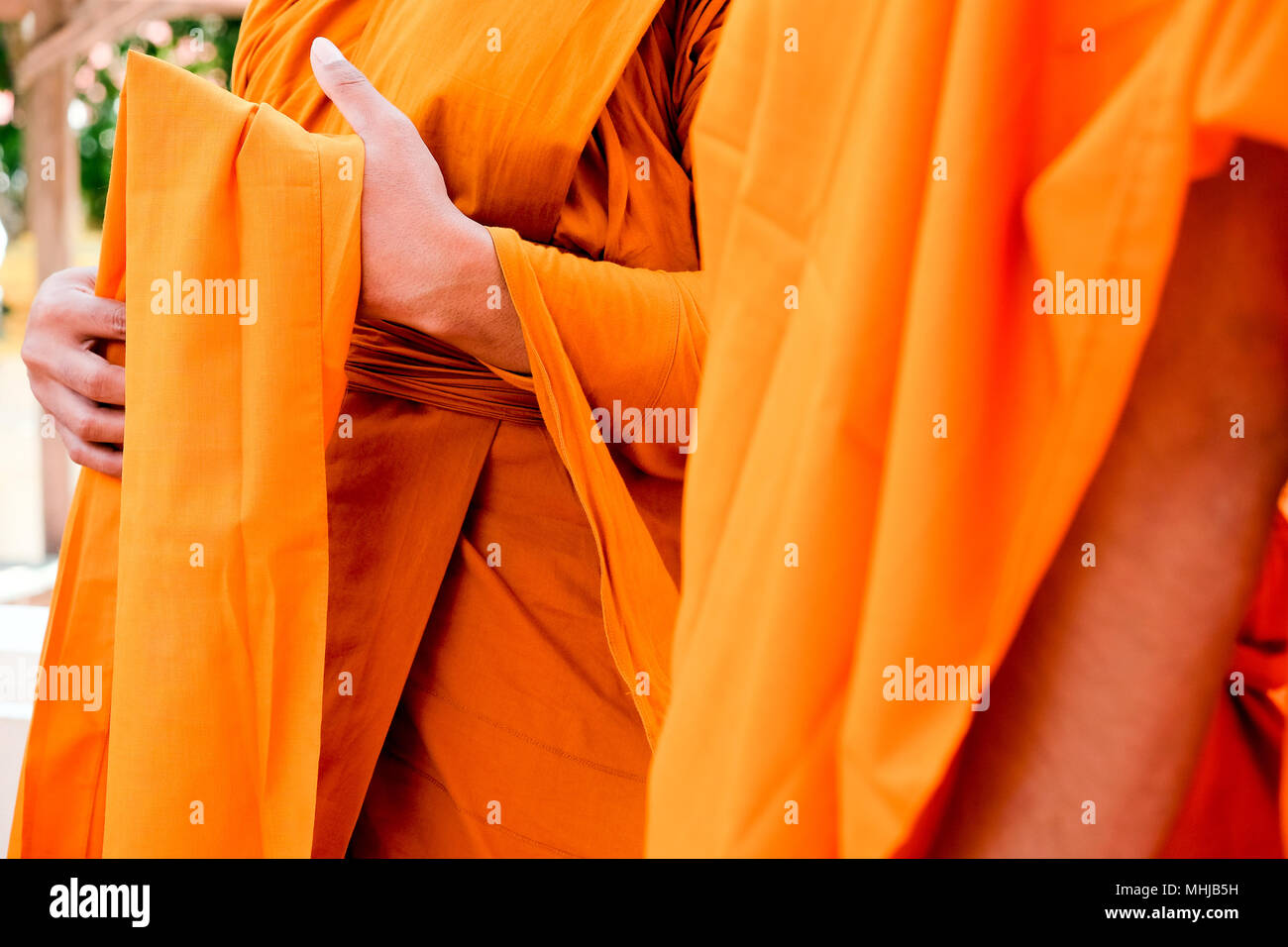 Yellow robe of Buddhist monks, Closeup on buddhist monk Stock Photo - Alamy