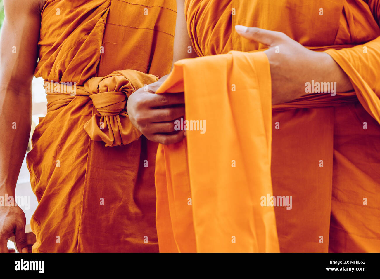 Yellow robe of Buddhist monks, Closeup on buddhist monk Stock Photo - Alamy