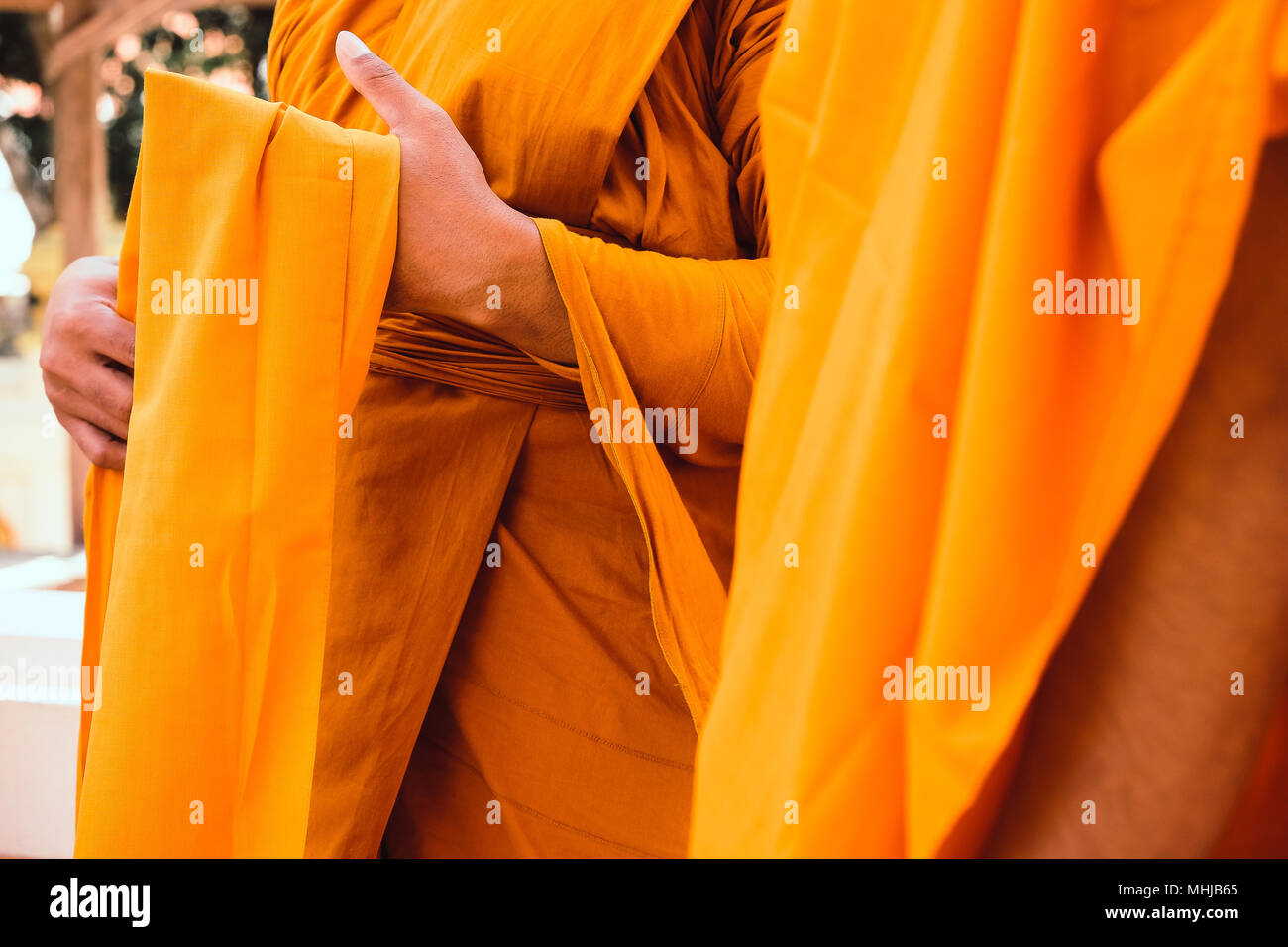 Yellow robe of Buddhist monks, Closeup on buddhist monk Stock Photo - Alamy