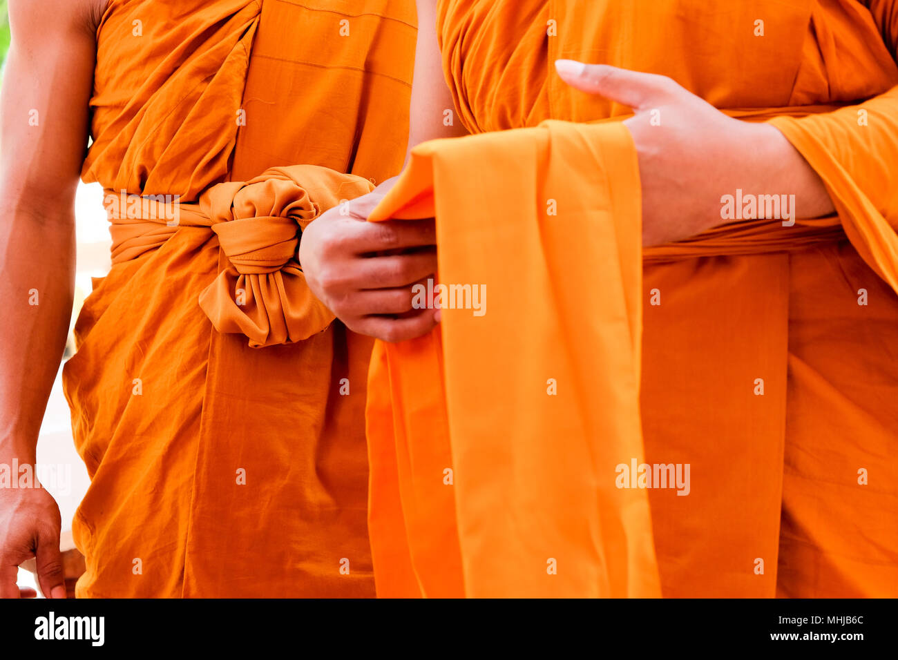 Yellow robe of Buddhist monks, Closeup on buddhist monk Stock Photo - Alamy