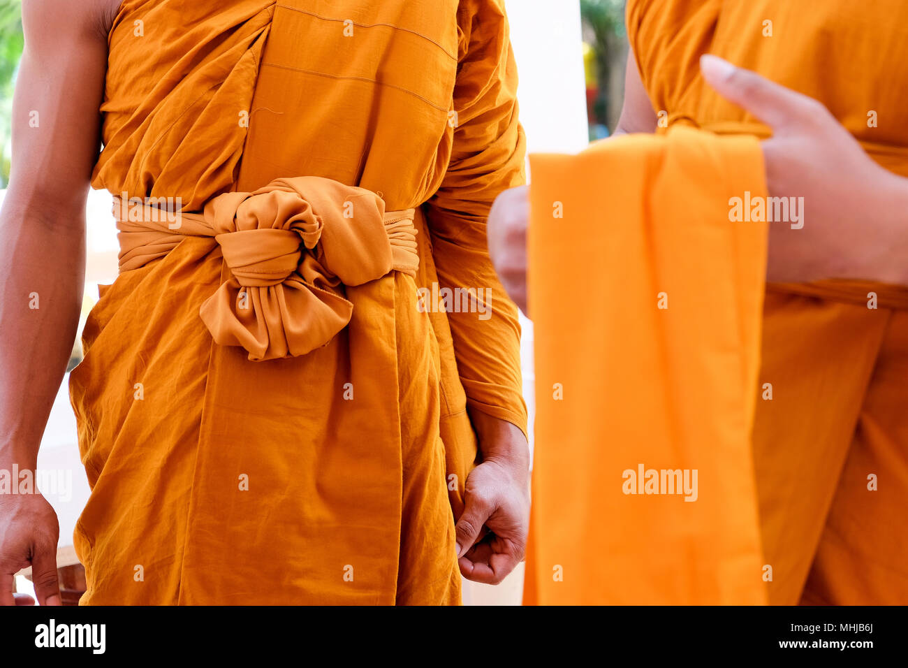 Yellow robe of Buddhist monks, Closeup on buddhist monk Stock Photo - Alamy