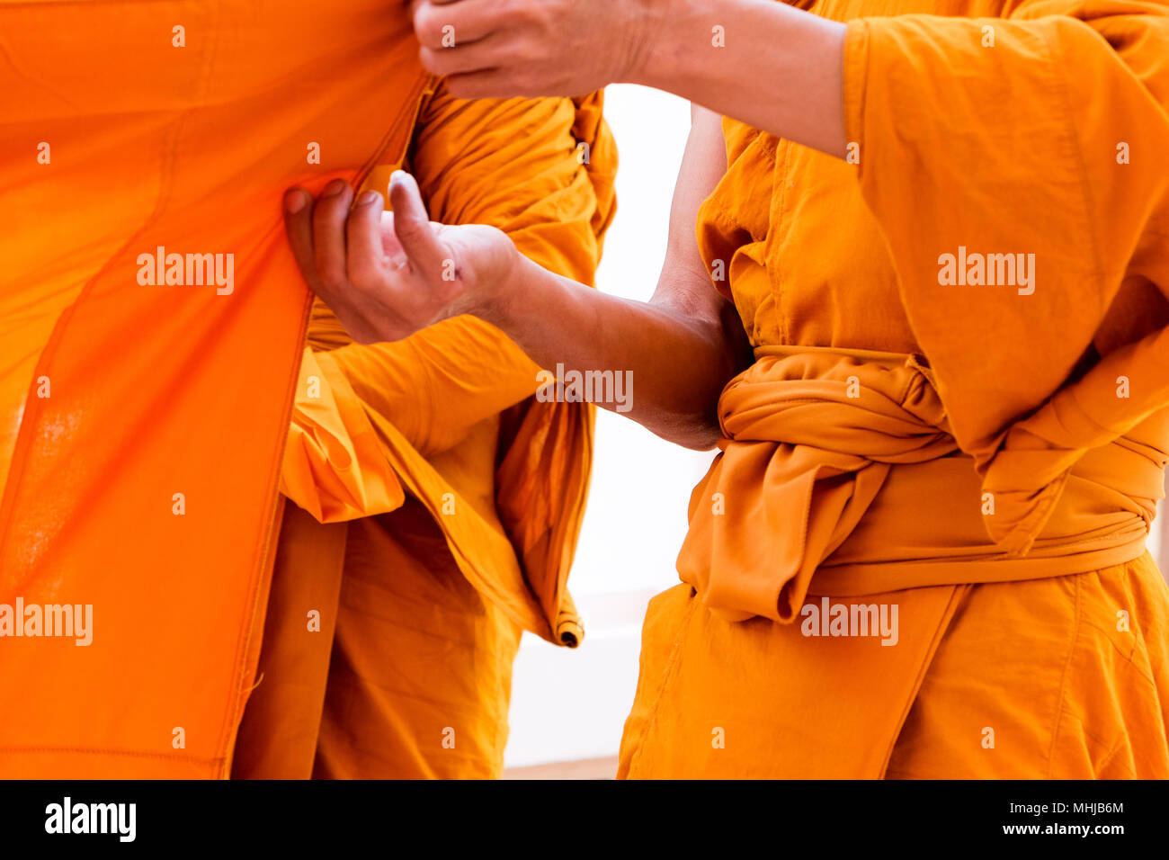 Yellow robe of Buddhist monks, Closeup on buddhist monk Stock Photo - Alamy