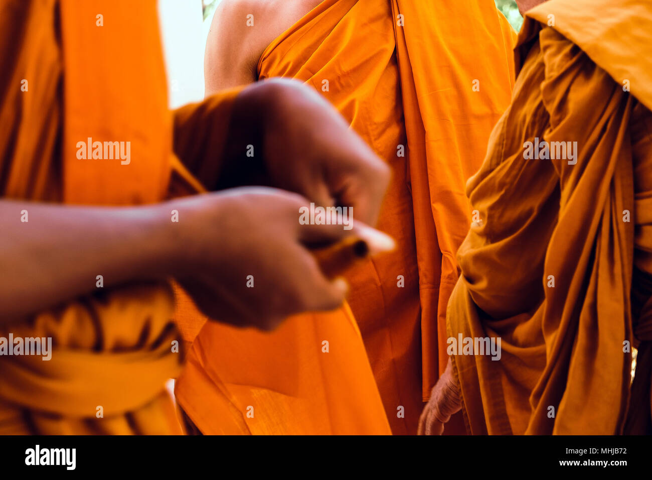 Yellow robe of Buddhist monks, Closeup on buddhist monk Stock Photo - Alamy