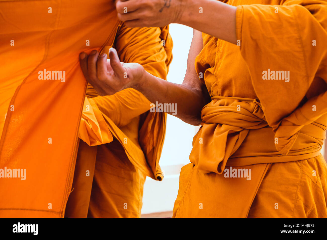 Yellow robe of Buddhist monks, Closeup on buddhist monk Stock Photo - Alamy