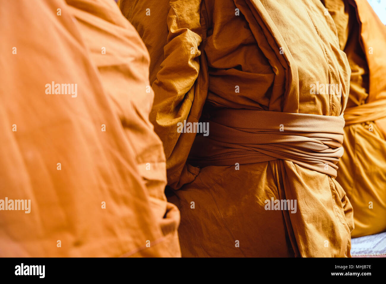 Yellow robe of Buddhist monks, Closeup on buddhist monk Stock Photo - Alamy