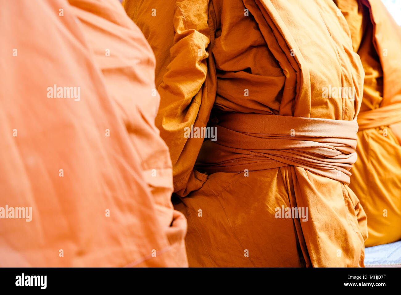 Yellow robe of Buddhist monks, Closeup on buddhist monk Stock Photo - Alamy