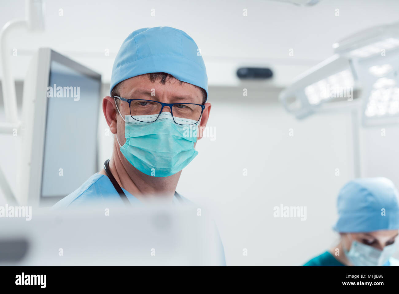 Anesthetist watching patient sleeping in operation room Stock Photo - Alamy