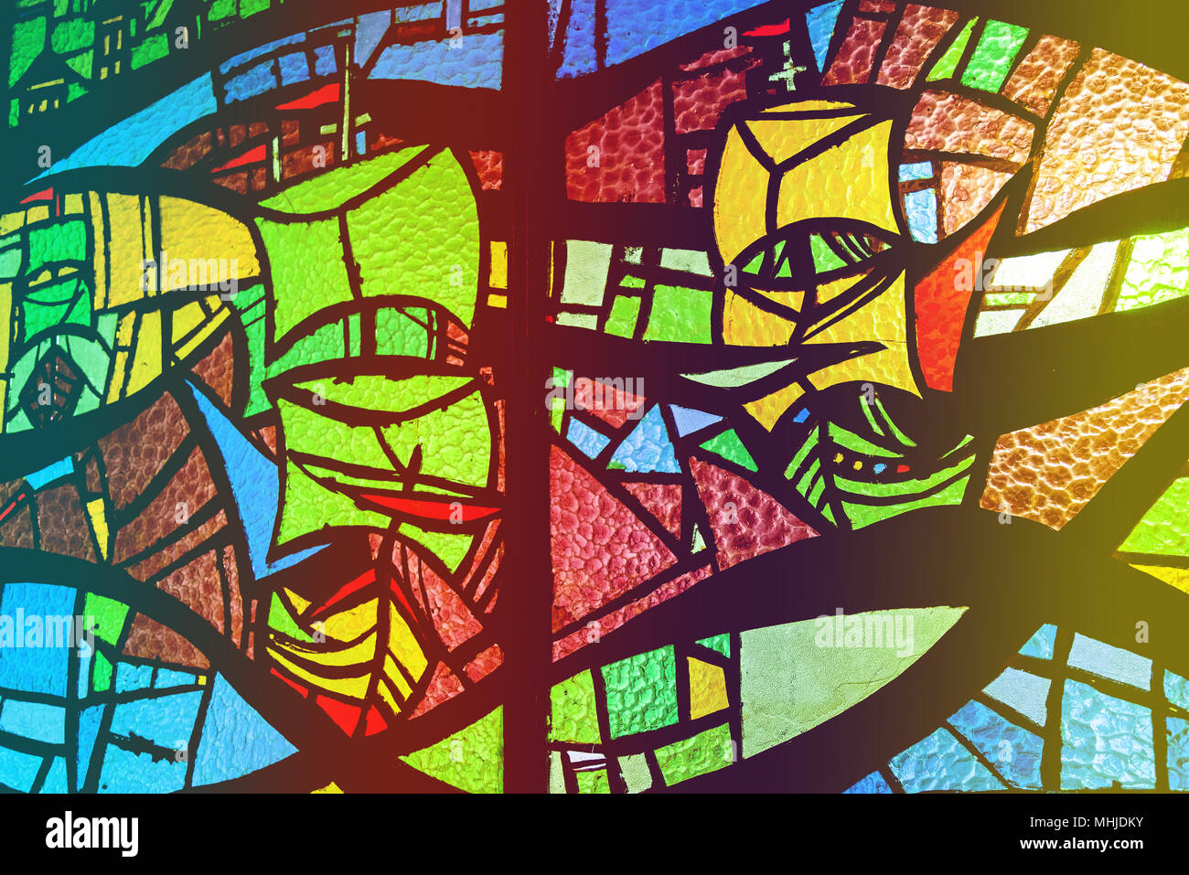 Image of a multi-colored stained-glass window with an abstract pattern ...
