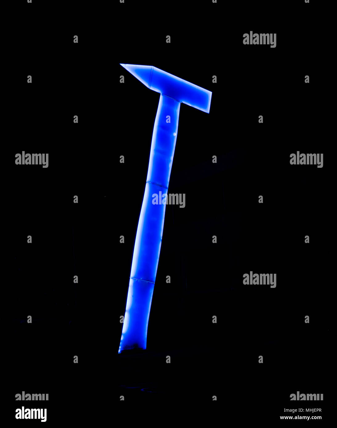 huge and tall blue neon hammer in the dark night Stock Photo - Alamy