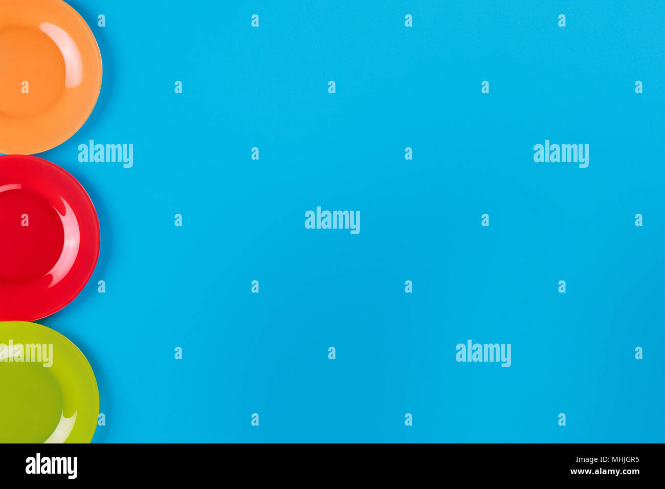 Blue surface with colored plates. Template and background Stock Photo ...