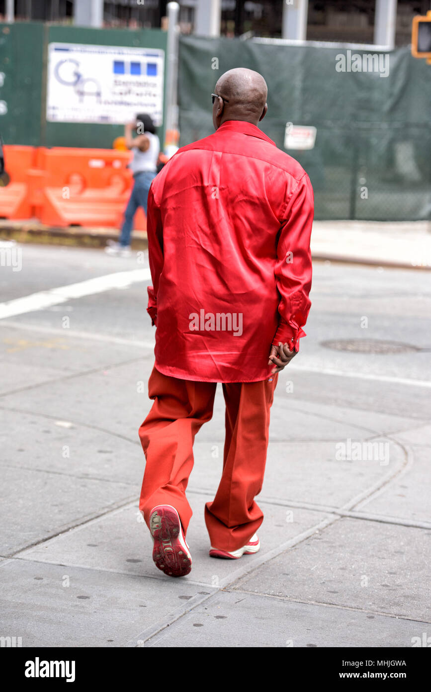 NEW YORK, USA - JUNE 15, 2015 - Red dressed black man walking in Harlem ...
