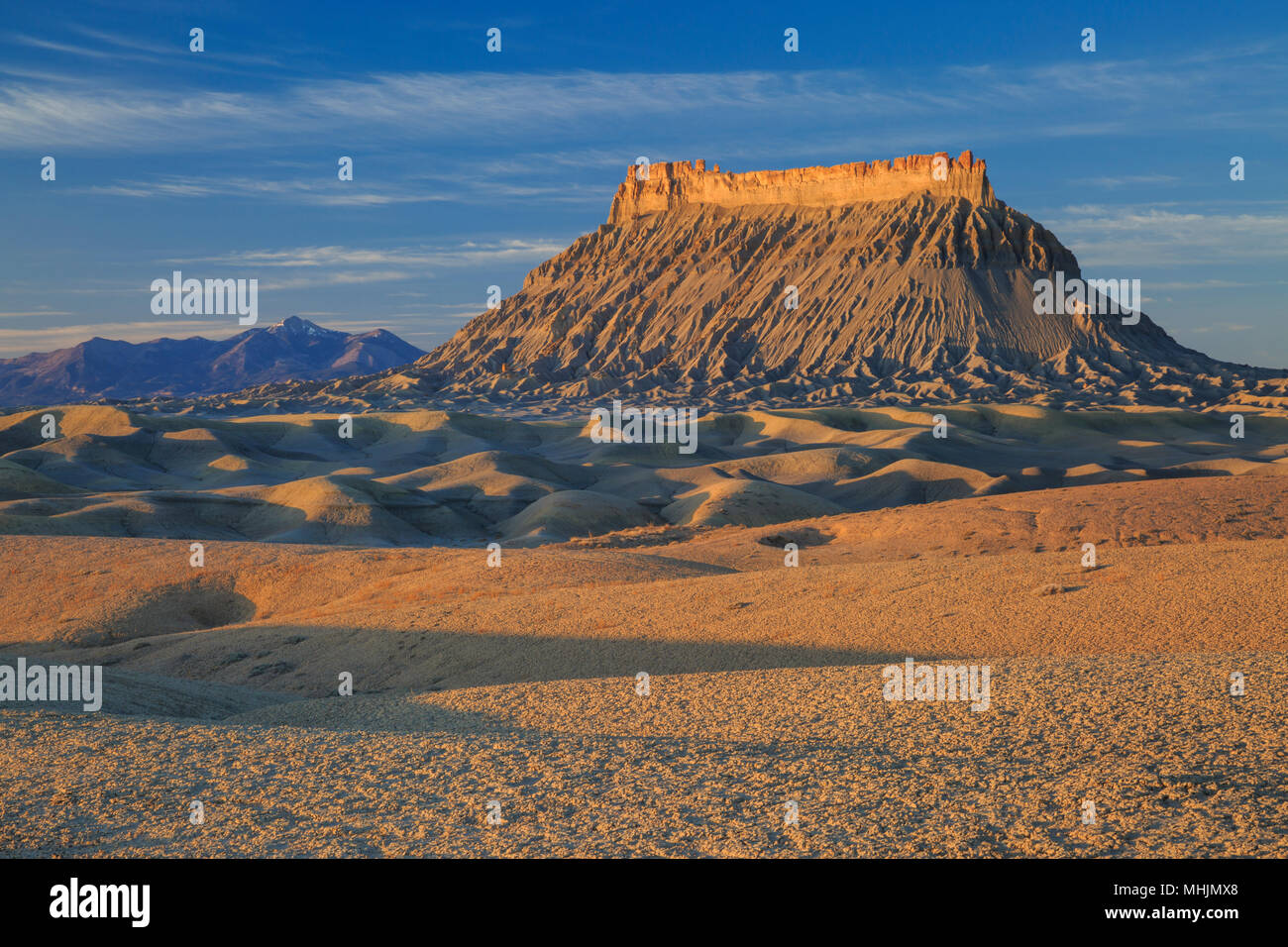 morning light on factory butte and distant henry mountains near ...