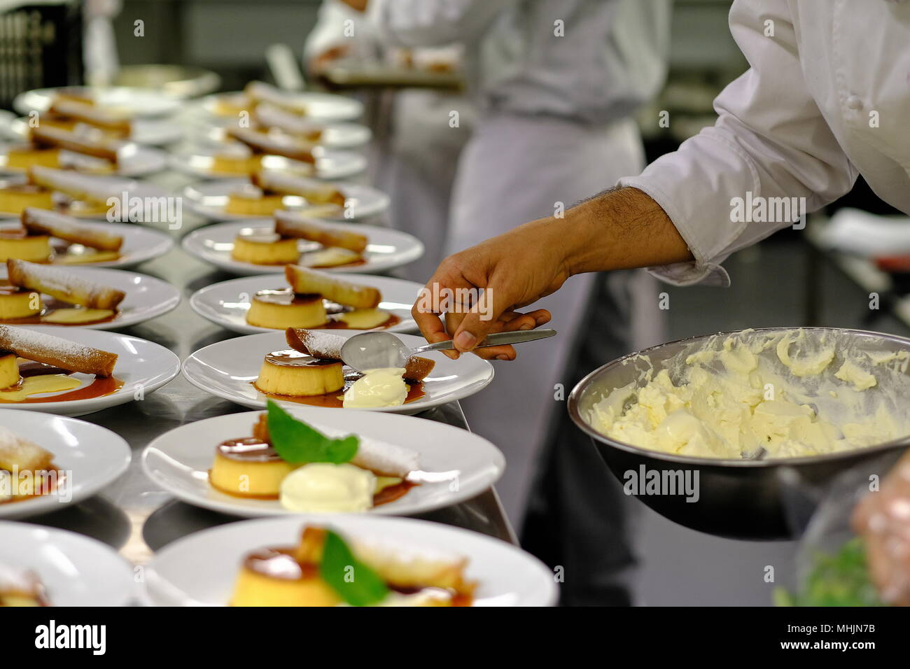 student preparing meals for their graduation guests at a cooking school ...