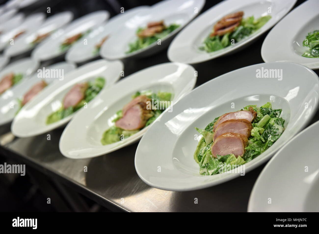 student preparing meals for their graduation guests at a cooking school ...