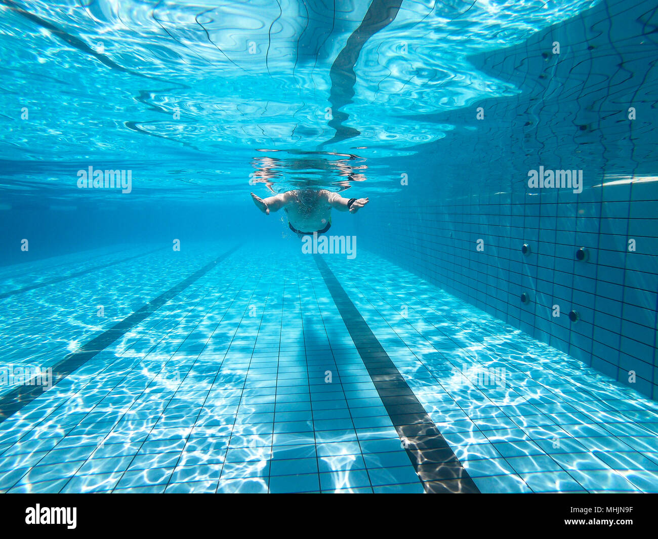 Underwater view of man in swimming pool Stock Photo - Alamy
