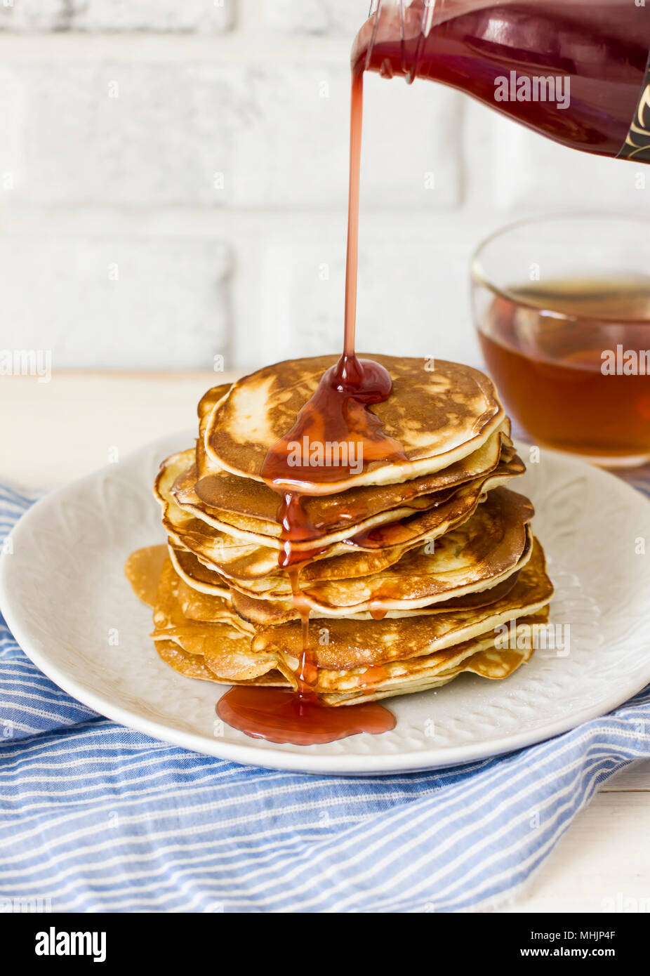 Homemade pancake poured syrup drops in white plate, closeup Stock Photo ...