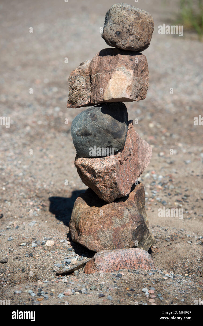 Rocks in equilibrium on the sand Stock Photo - Alamy