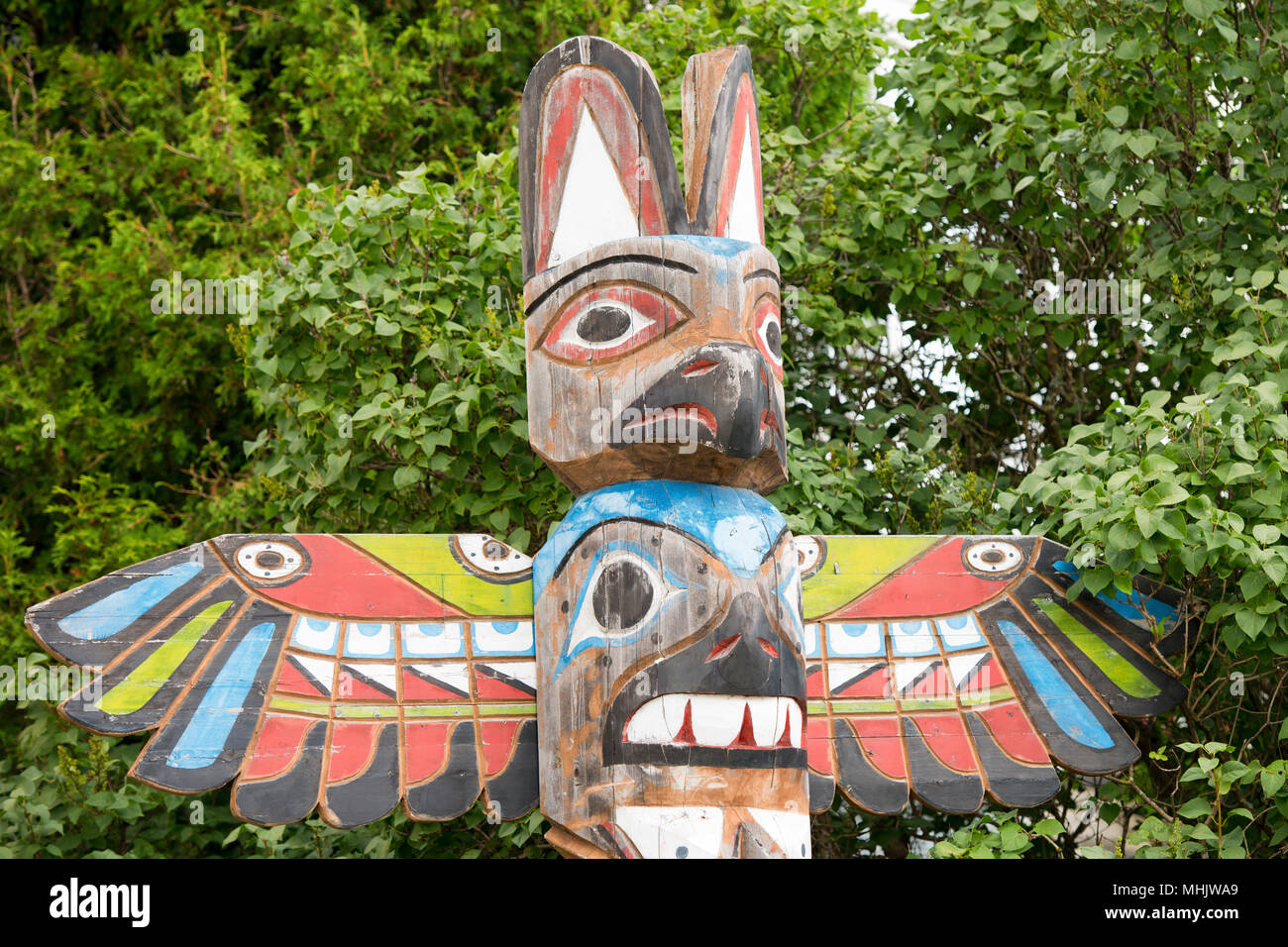 Isolated totem wood pole in the forest background Stock Photo - Alamy